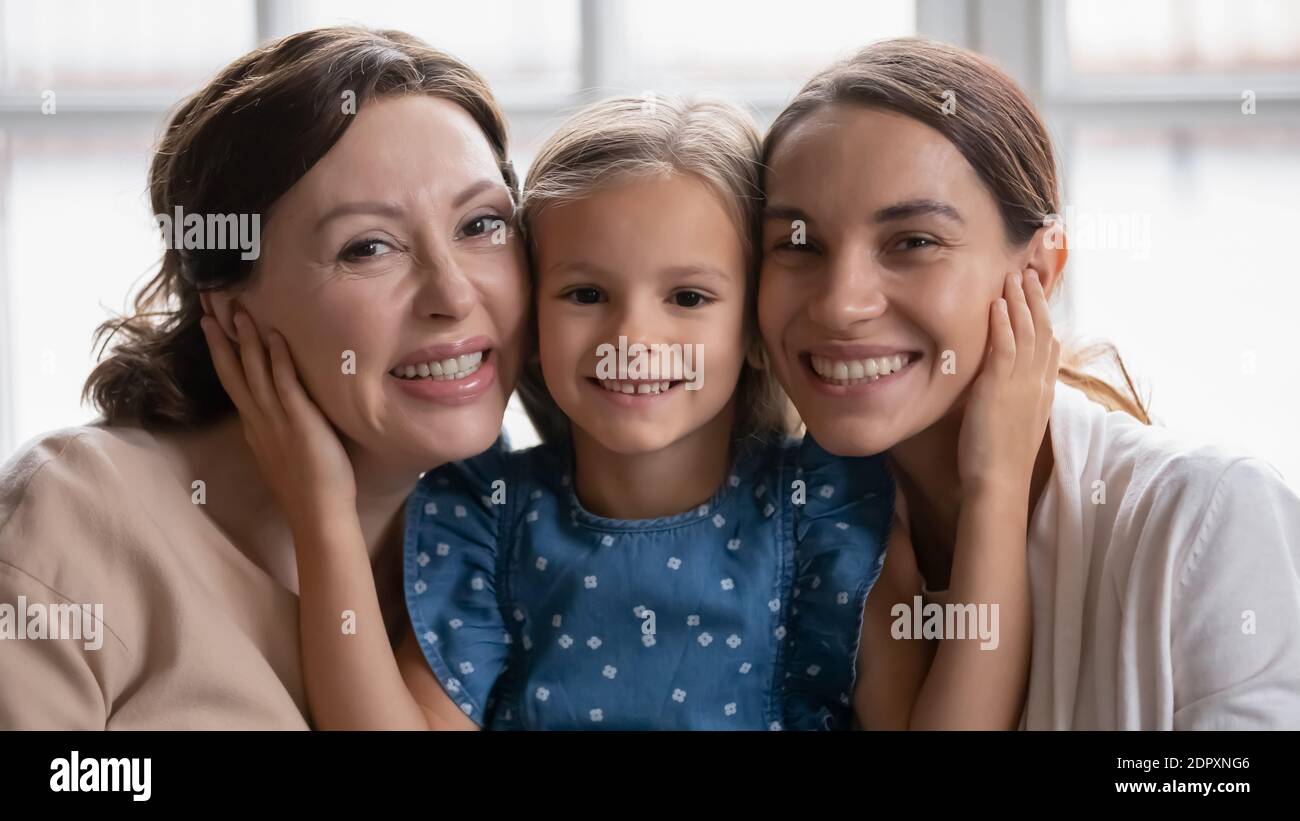 Head shot portrait smiling three generations of women posing together ... Head shot portrait smiling three generations of women posing together ...