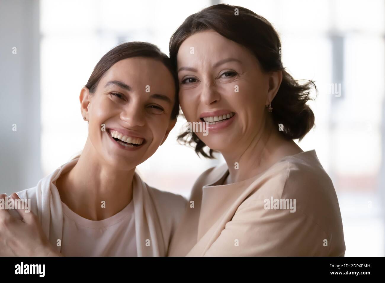 Head shot portrait smiling middle aged mother and grownup daughter ... Head shot portrait smiling middle aged mother and grownup daughter ...