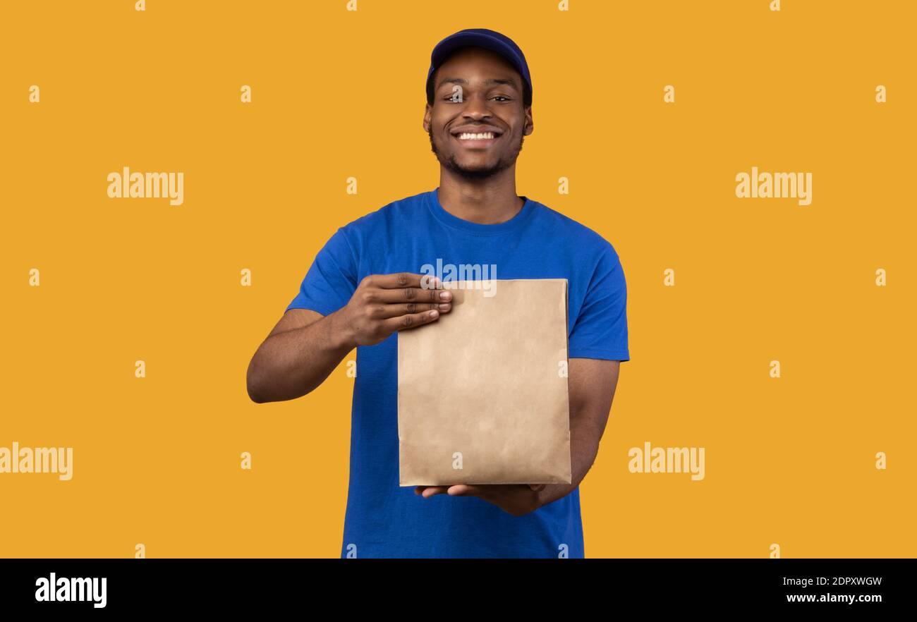 Courier smiling guy with package hi-res stock photography and images ...