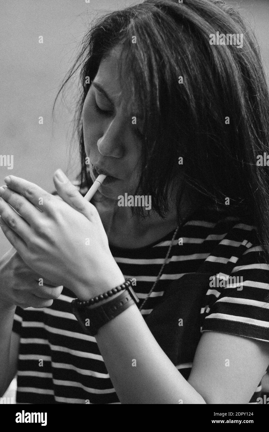 Asian woman smoking cigarette standing Black and White Stock Photos ...