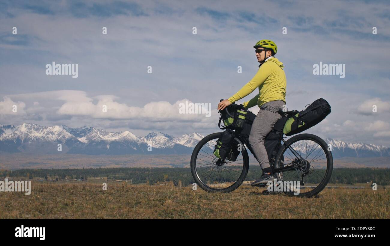 The man travel on mixed terrain cycle touring with bikepacking. The ...