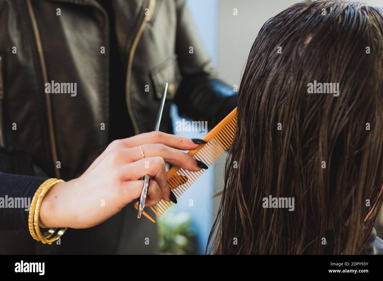 stylist combing brown hair Stock Photo - Alamy