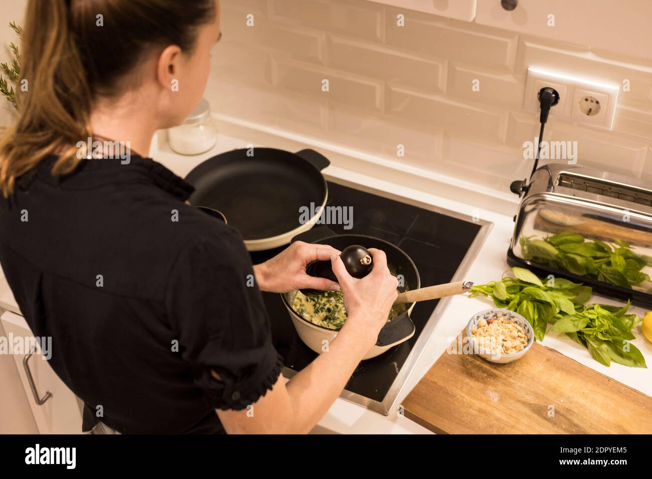 Woman grinding pepper hi-res stock photography and images - Alamy