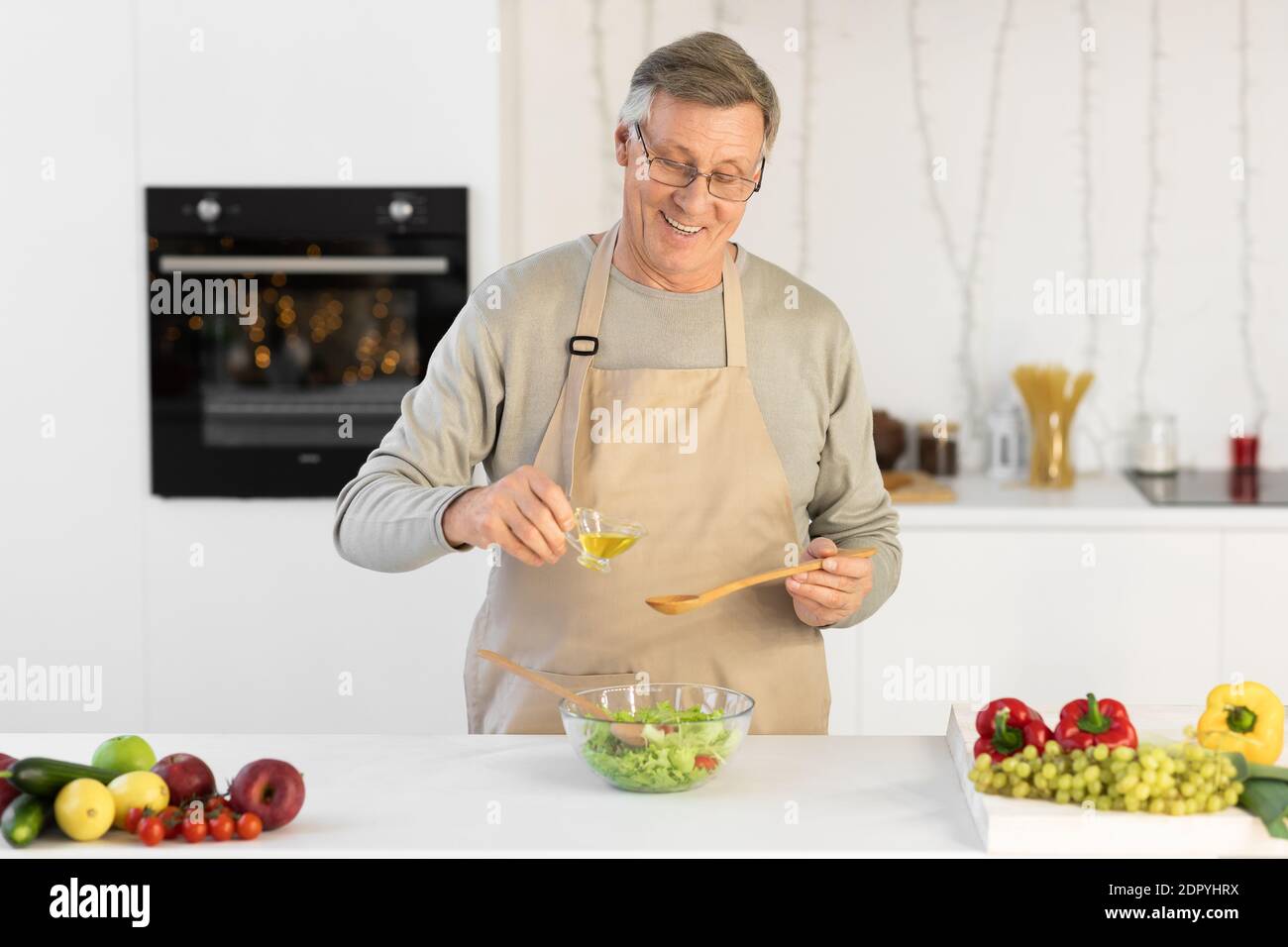 Senior man cooking home hi-res stock photography and images - Alamy