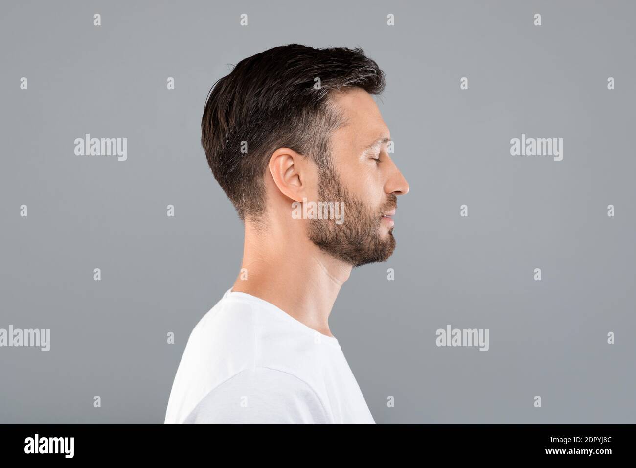 Side view of middle-aged man over grey background Stock Photo - Alamy