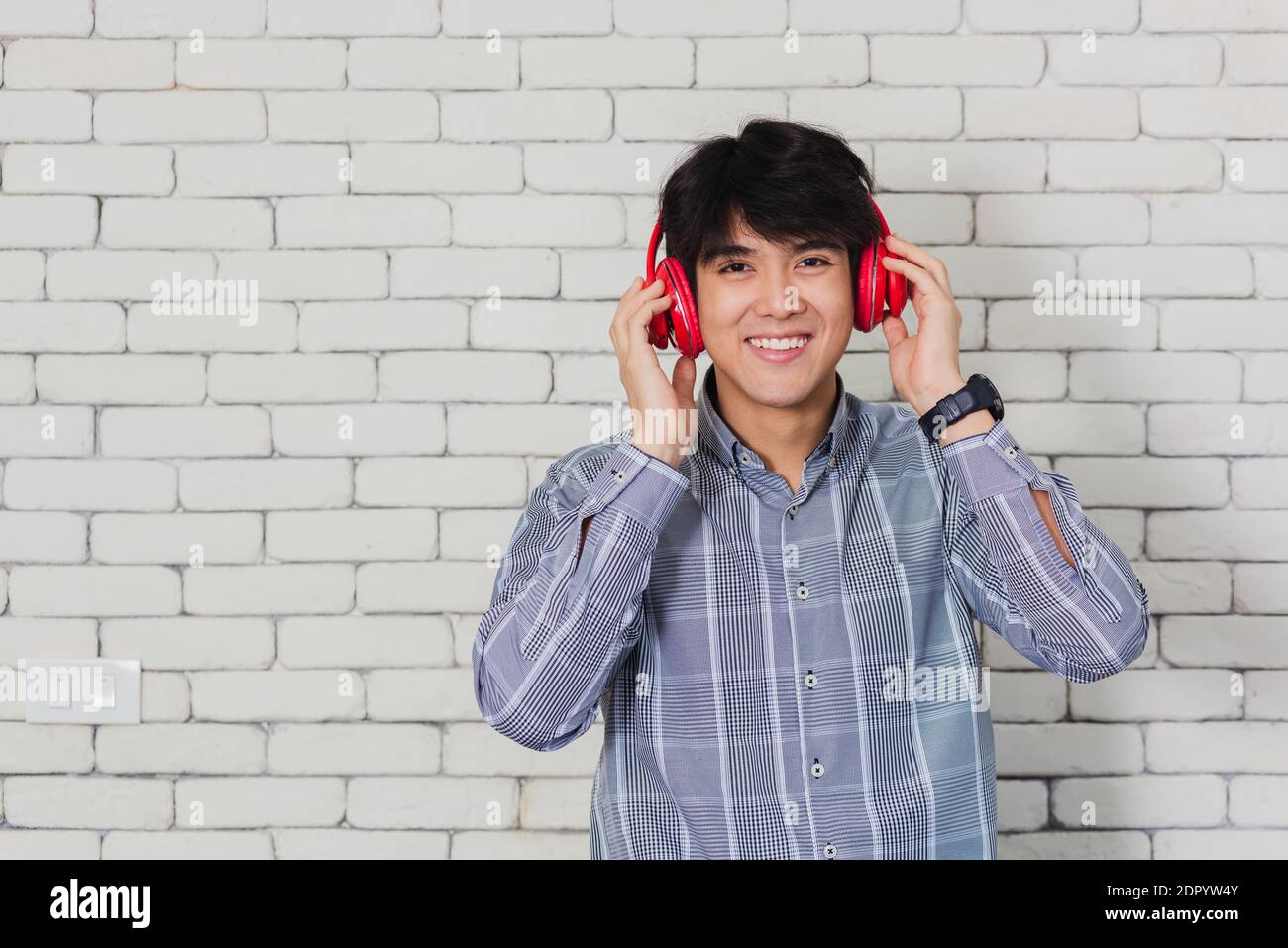 Portrait of Asian handsome young man he smile listening to music in ...
