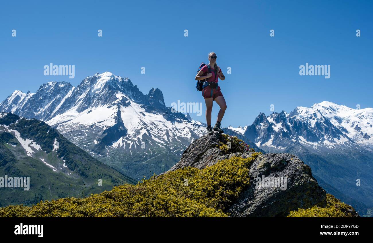 Hiker standing on rocks, mountain panorama from Aiguillette des ...