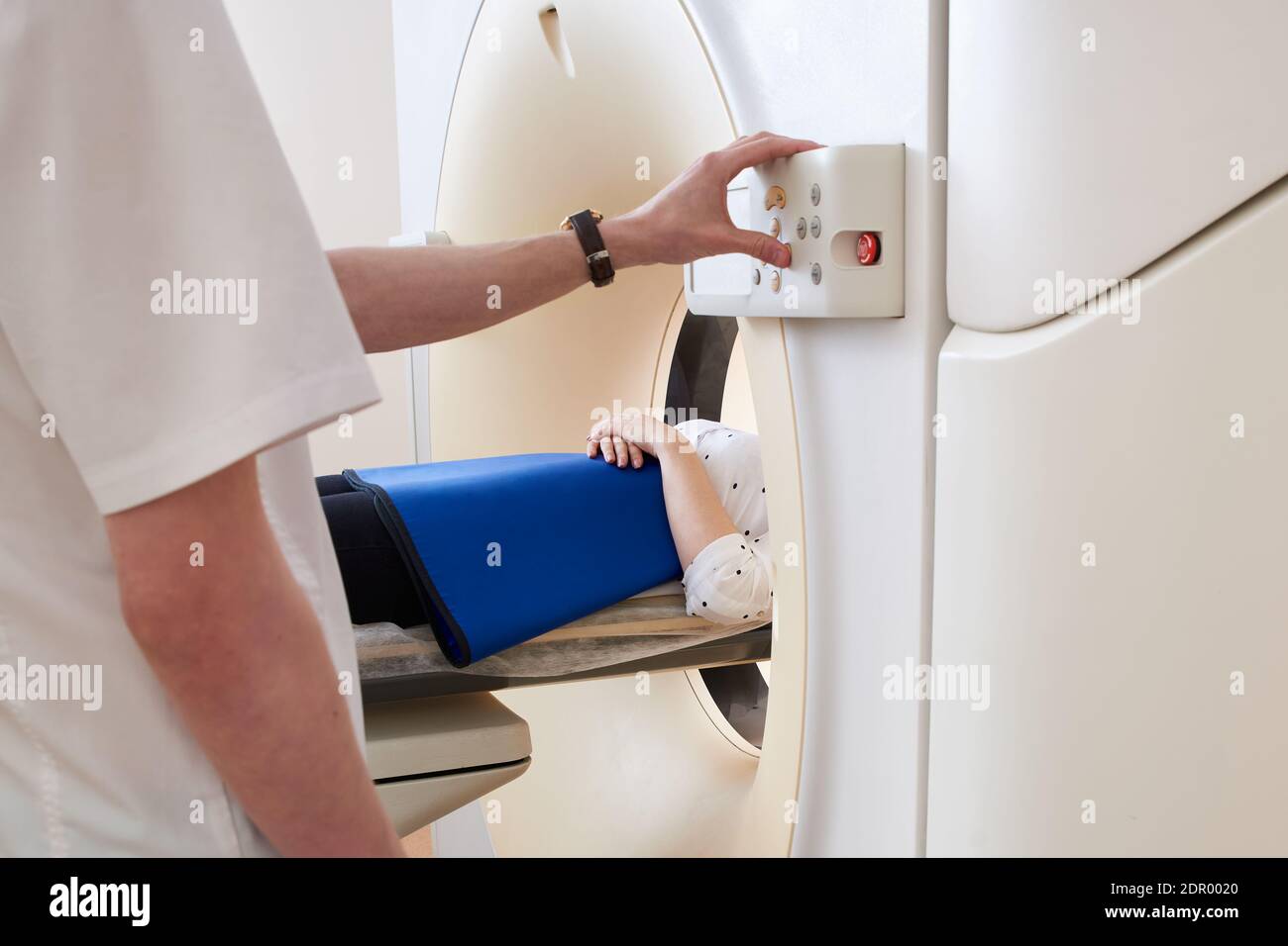 Woman going through a Computerized Axial Tomography CAT scanner. Doctor ...