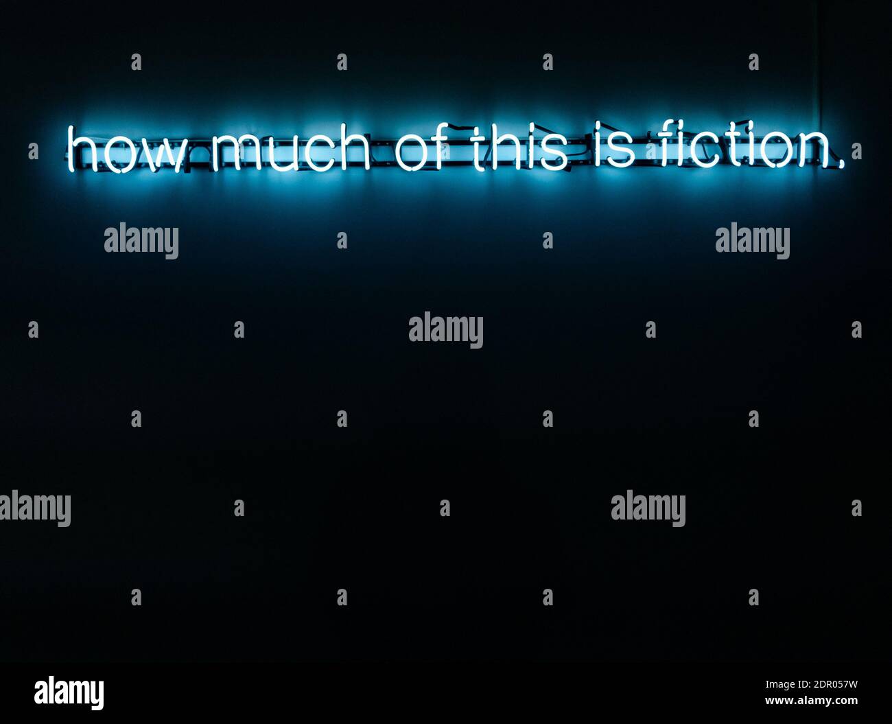 Illuminated Blue Neon Text In Darkroom Stock Photo - Alamy