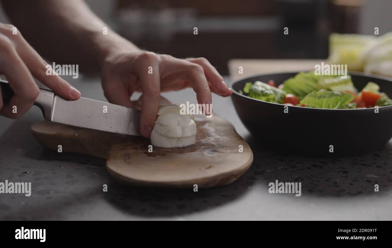 Man hands slicing mozzarella hi-res stock photography and images - Alamy