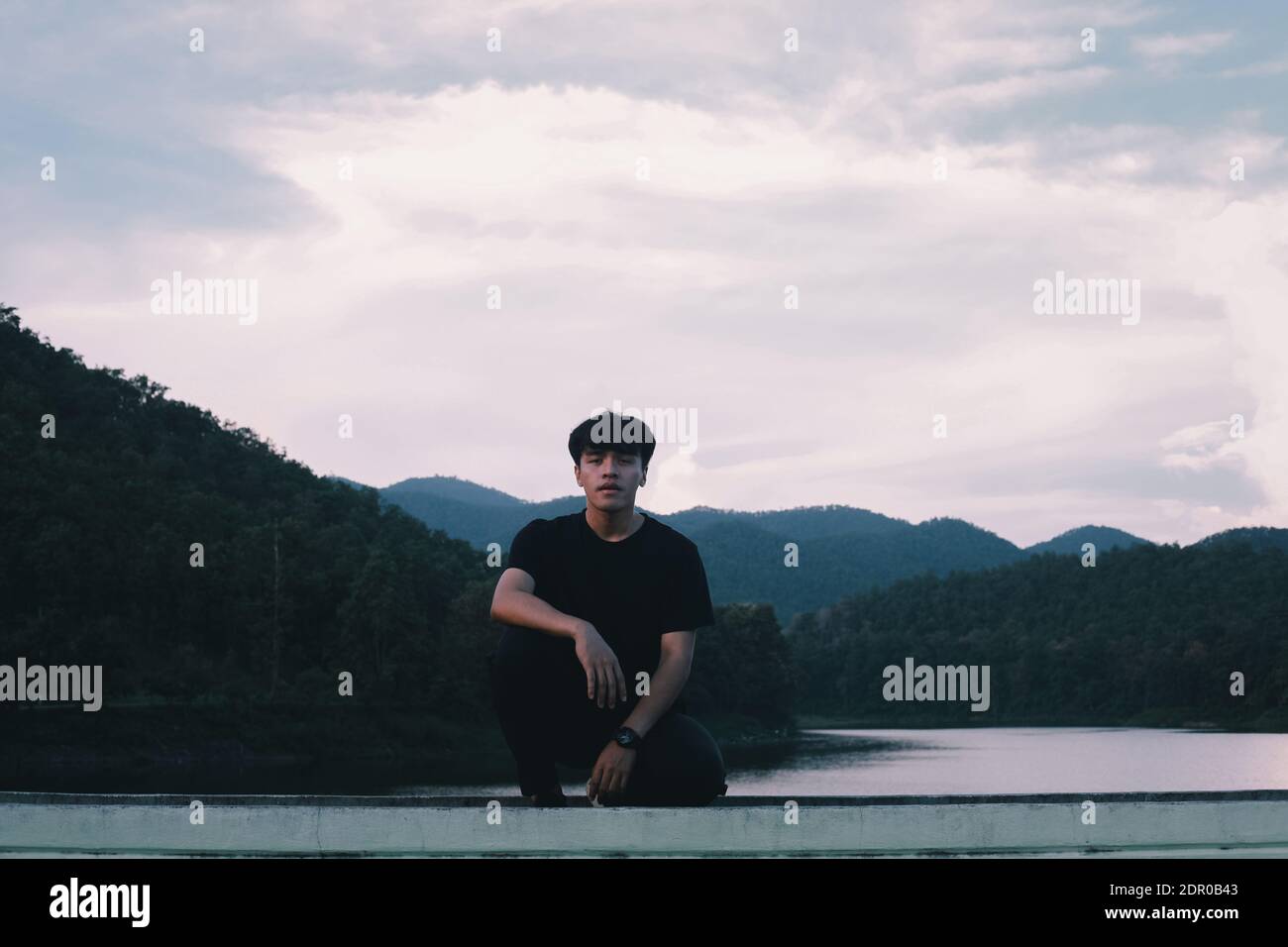 Indian man crouching on wall hi-res stock photography and images - Alamy