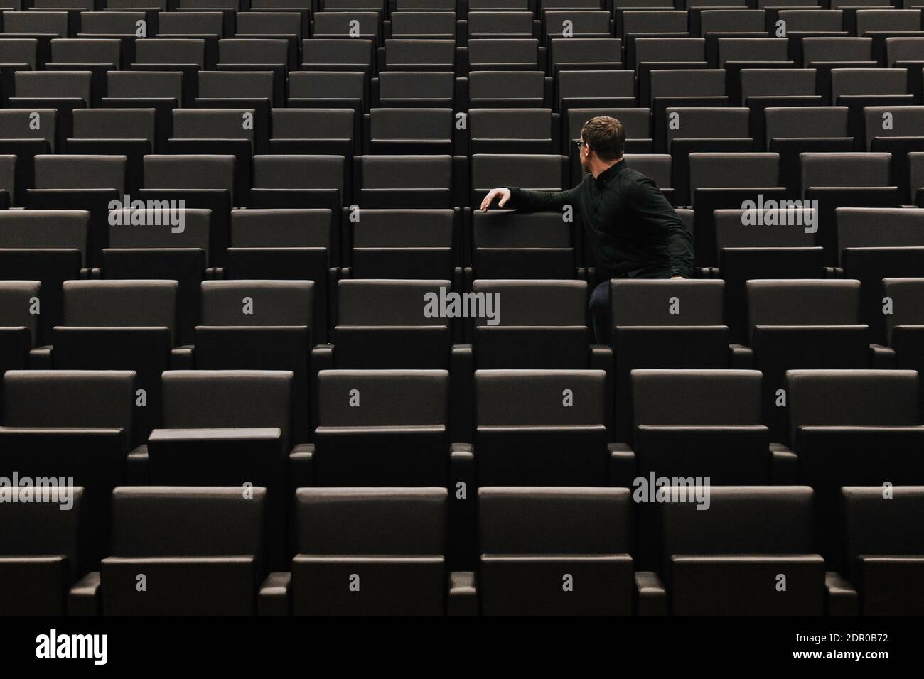 Man sitting alone in auditorium hi-res stock photography and images - Alamy