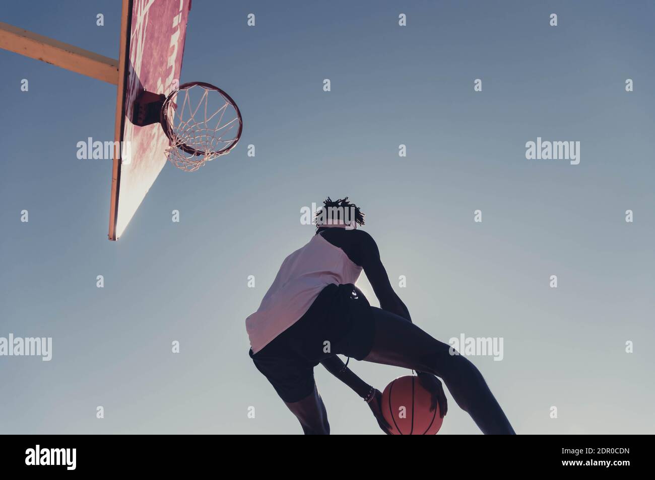 Rear view young man holding basketball hi-res stock photography and ...