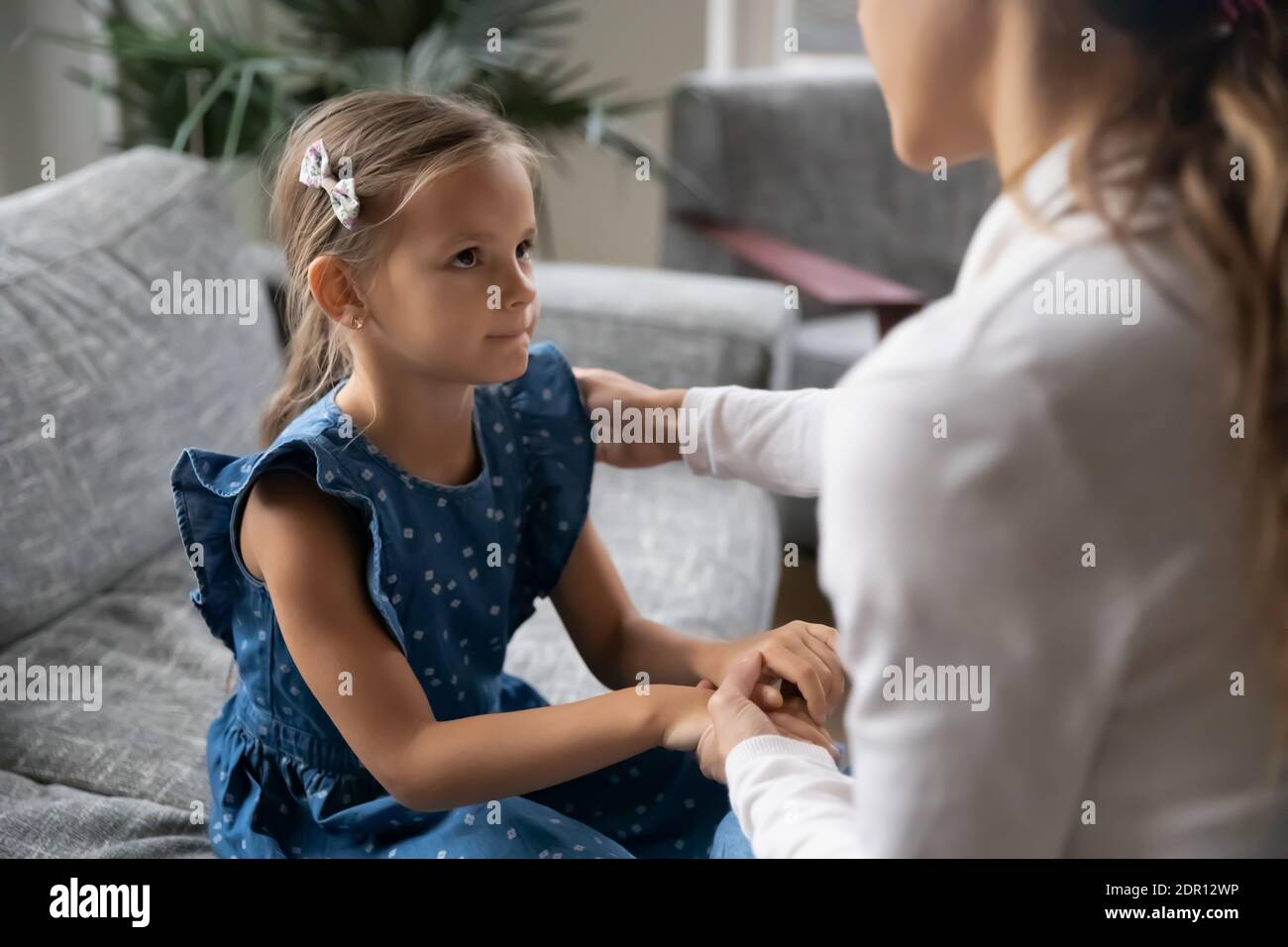 Close up loving mother touching upset little daughter shoulder Stock ...