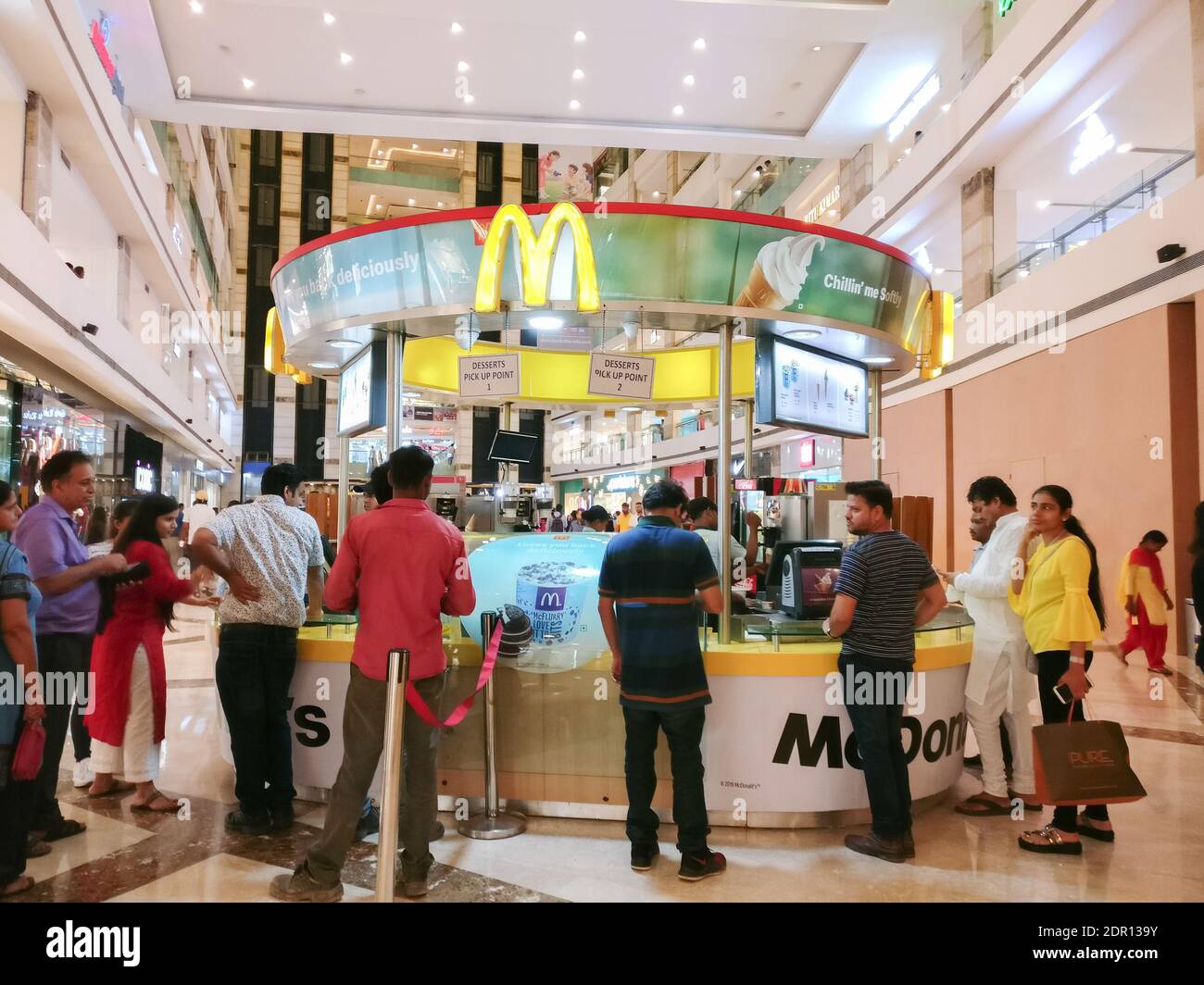 People waiting as a crowd in front of a Mcdonalds outlet in a shopping ...