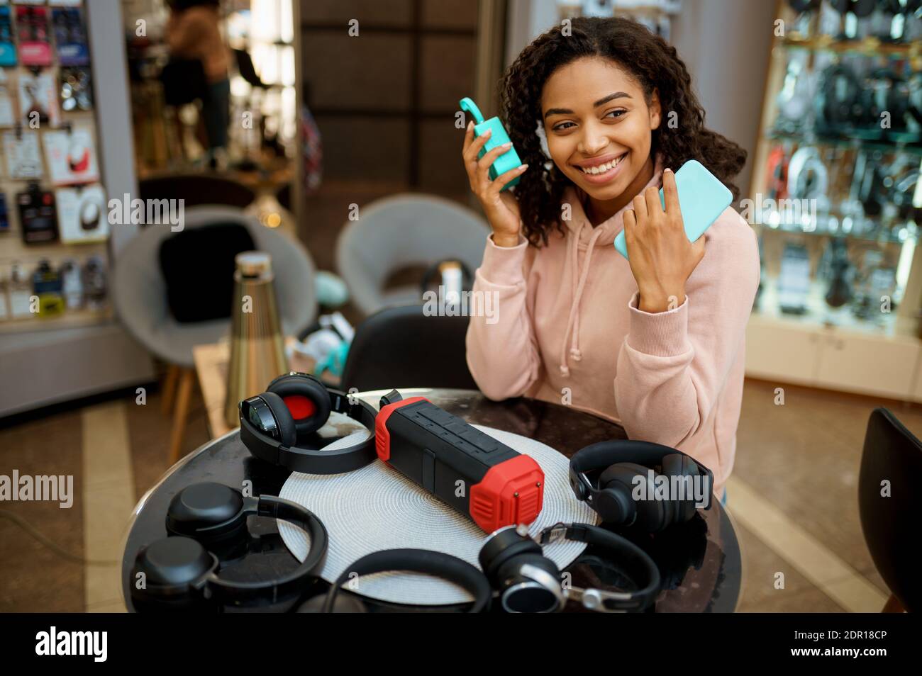 Customer buying headphones in store, music fan Stock Photo - Alamy