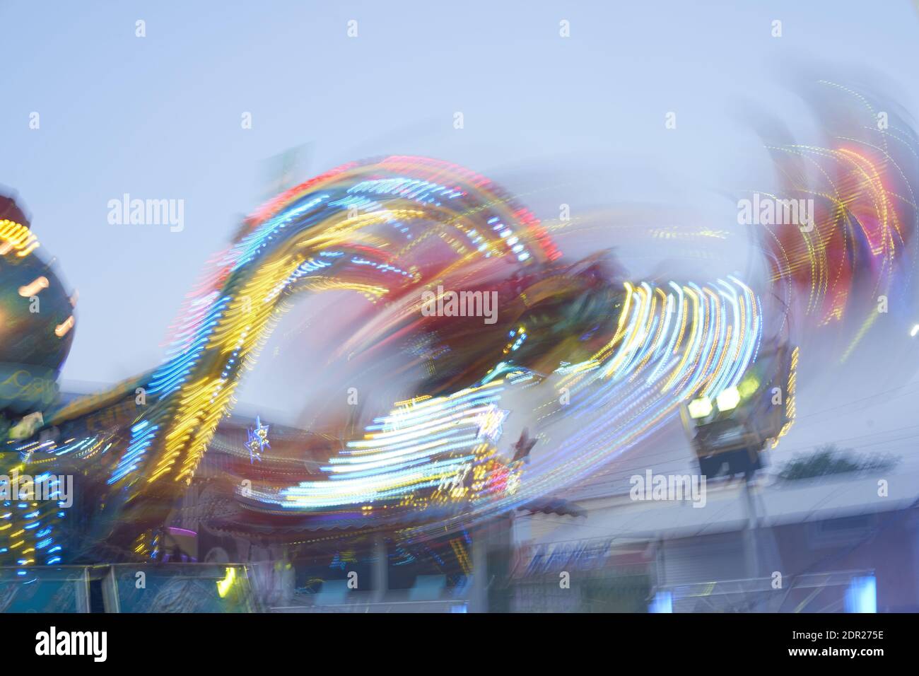 Amusement park blurred effect. Abstract illuminated background Spinning ...
