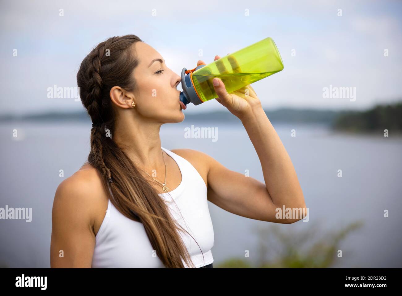 Female Athlete Drinking Water During Outdoor Workout Stock Photo - Alamy