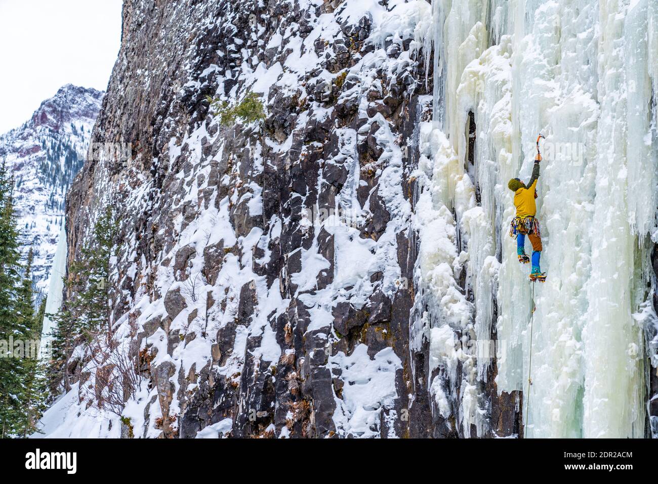 Ice climbers enjoying a day outside climbing frozen waterfalls in ...
