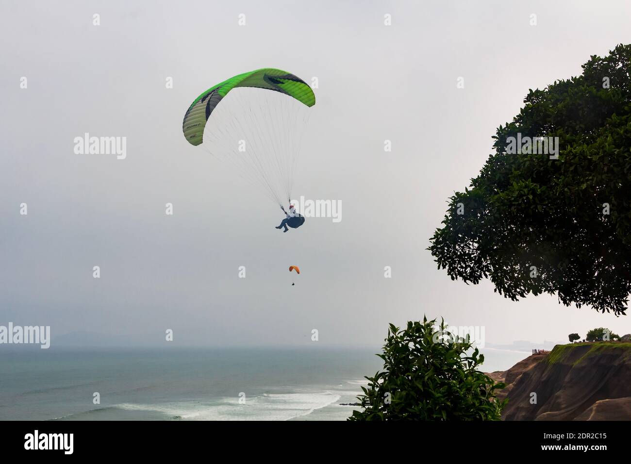 Lima, Peru - June 19, 2015: Paragliders sail over the Pacific Ocean off ...