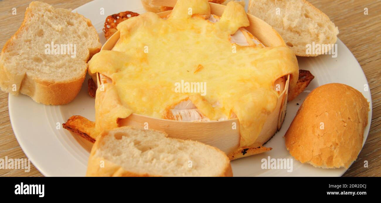 an oven-baked camembert with bread rolls Stock Photo - Alamy