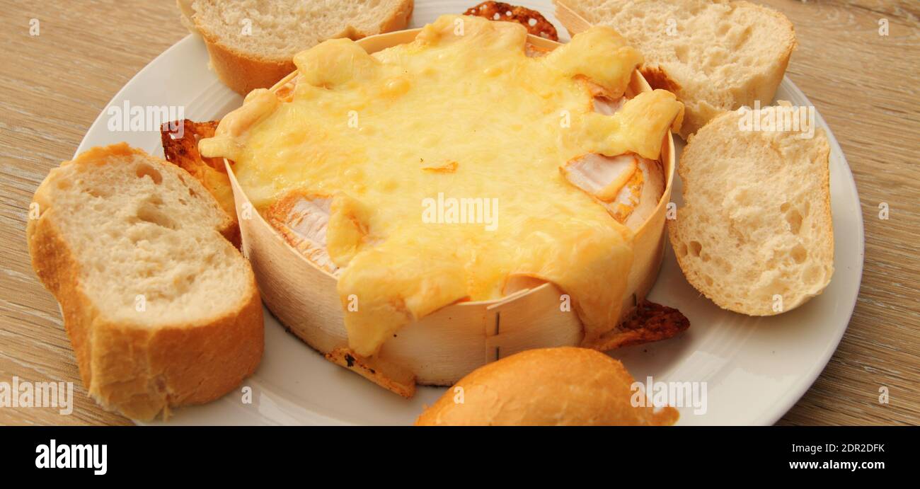 an oven-baked camembert with bread rolls Stock Photo - Alamy