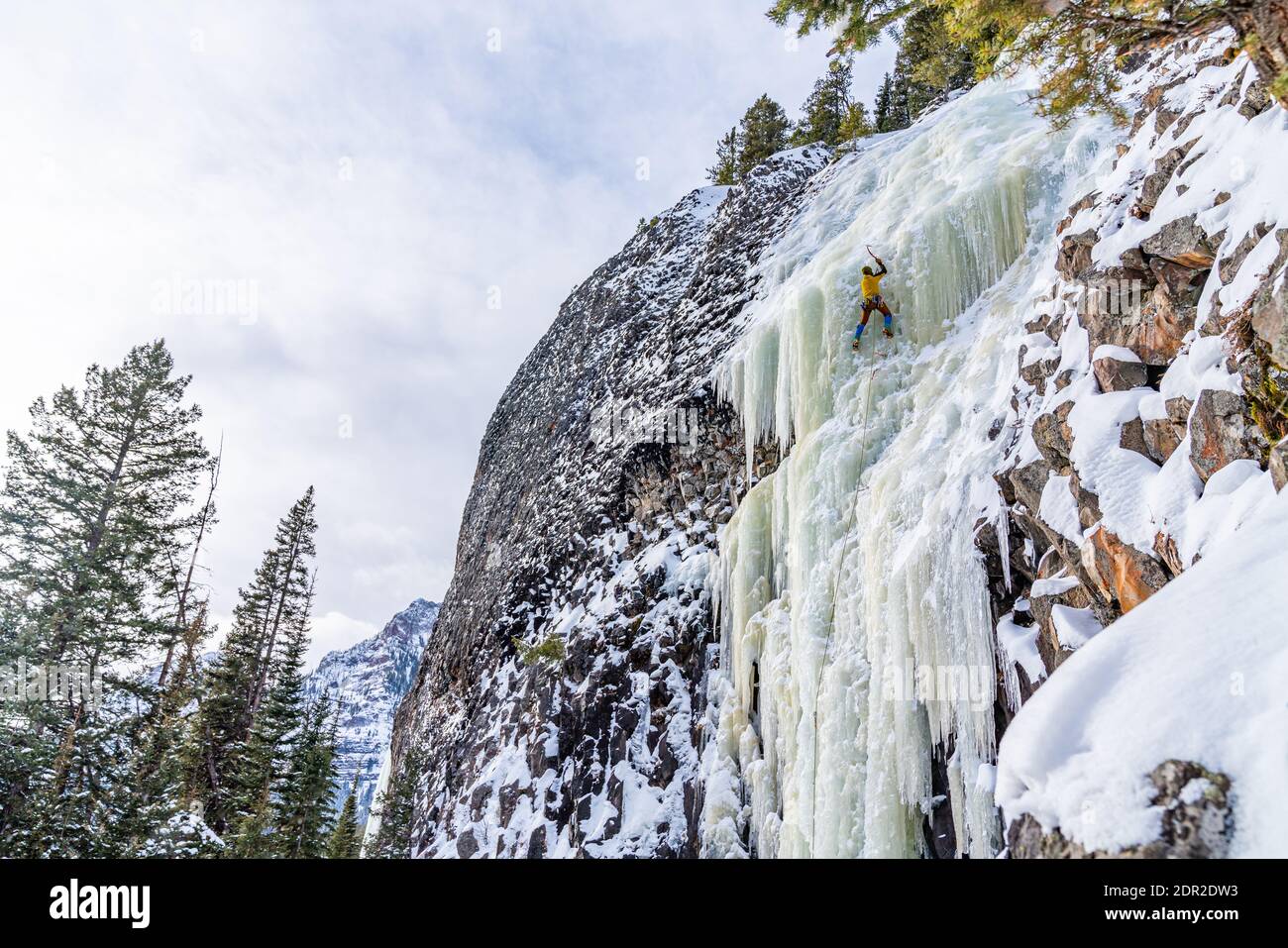 Ice climbers enjoying a day outside climbing frozen waterfalls in ...