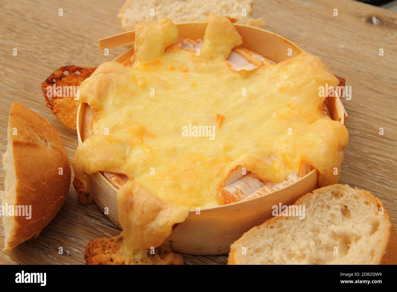 an oven-baked camembert with bread rolls Stock Photo - Alamy