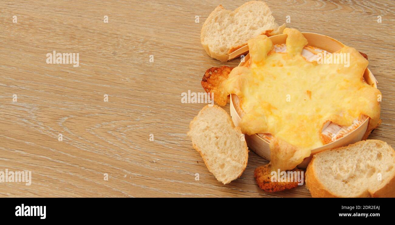 an oven-baked camembert with bread rolls Stock Photo - Alamy