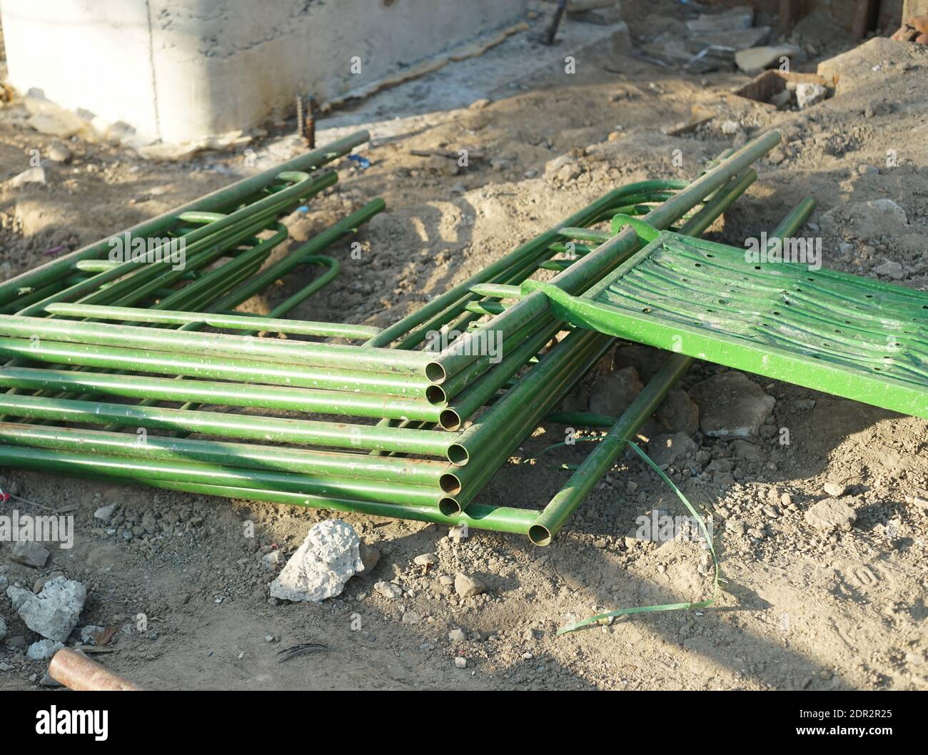 A green steel scaffolding total beside a cement pillar in the civil ...