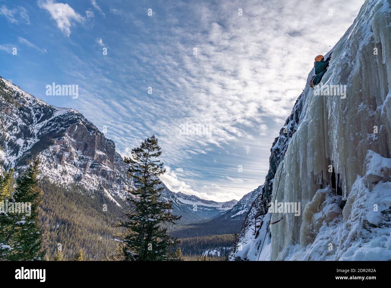 Ice climbers enjoying a day outside climbing frozen waterfalls in ...