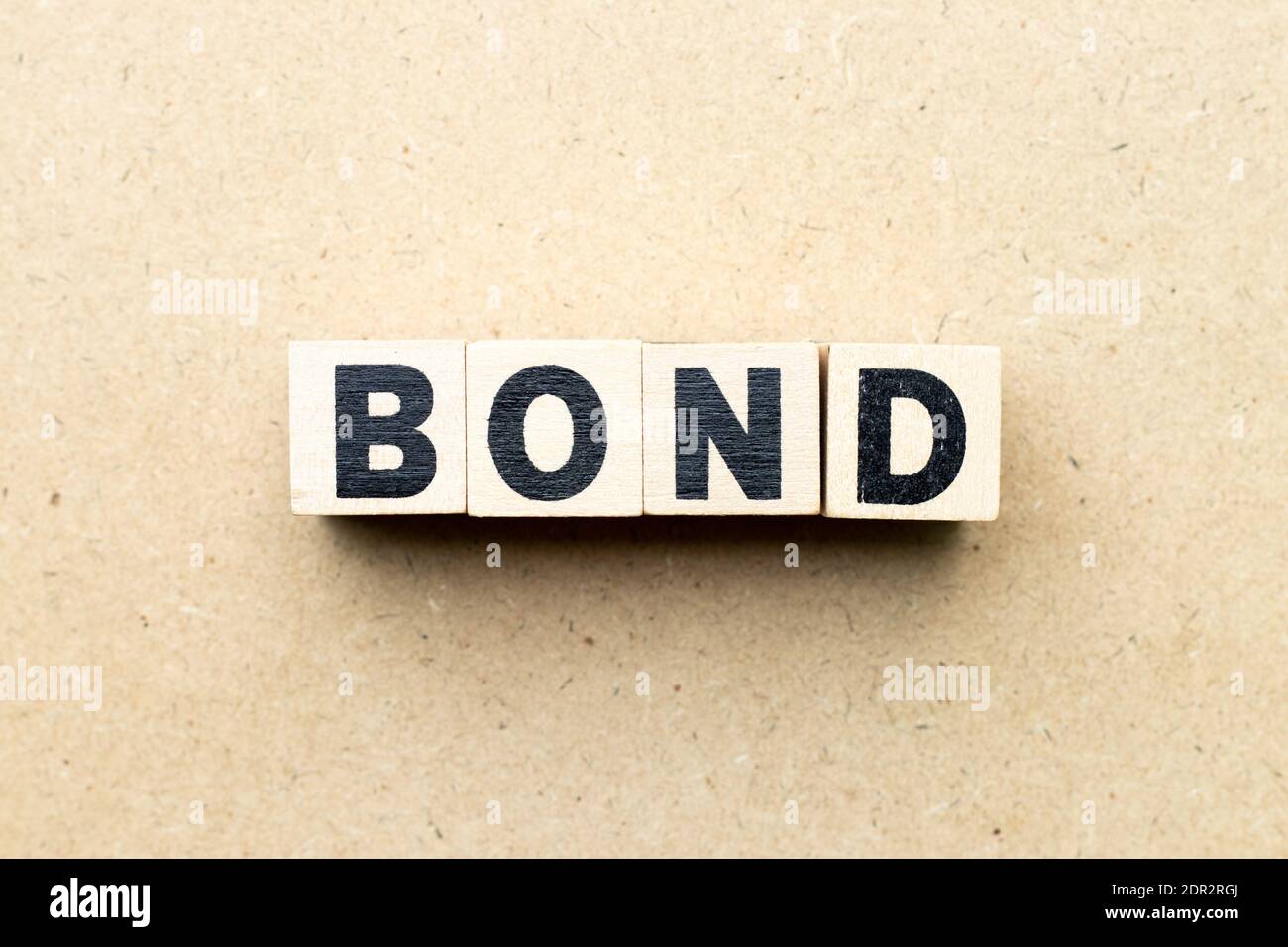 Alphabet letter block in word bond on wood background Stock Photo - Alamy