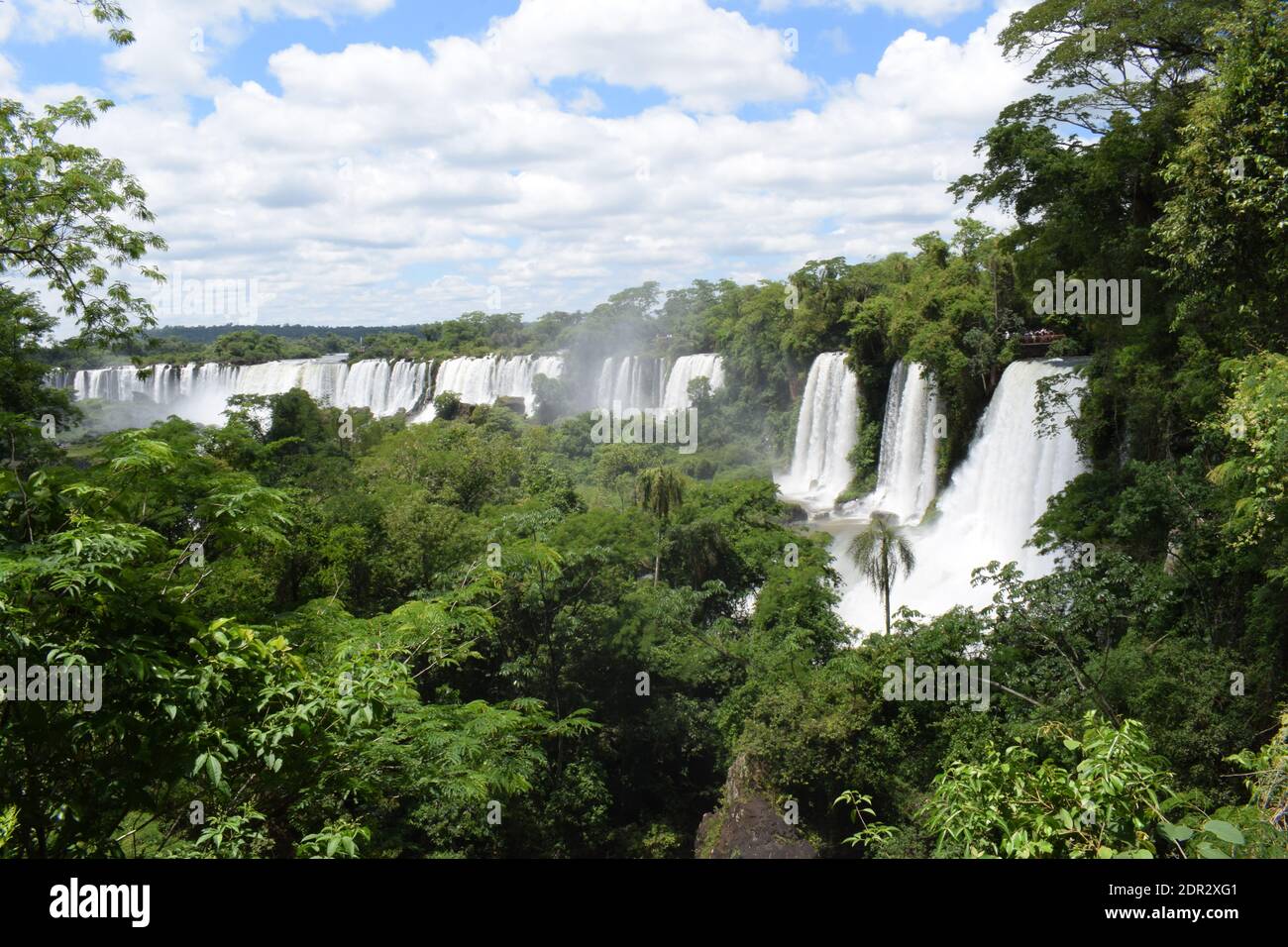A beautiful shot of waterfalls in the forests under a bright sky Stock ...