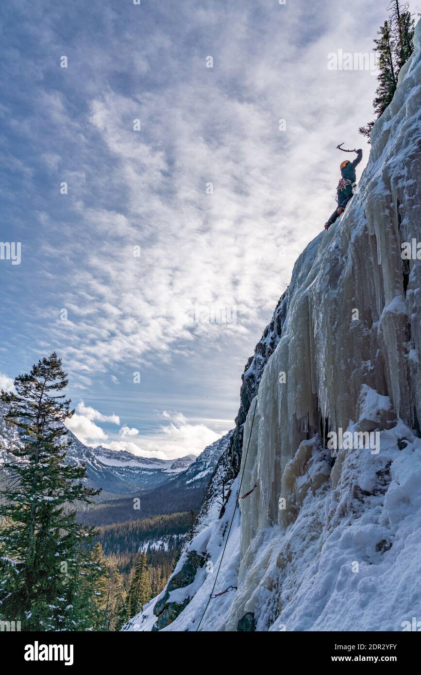 Ice climbers enjoying a day outside climbing frozen waterfalls in ...