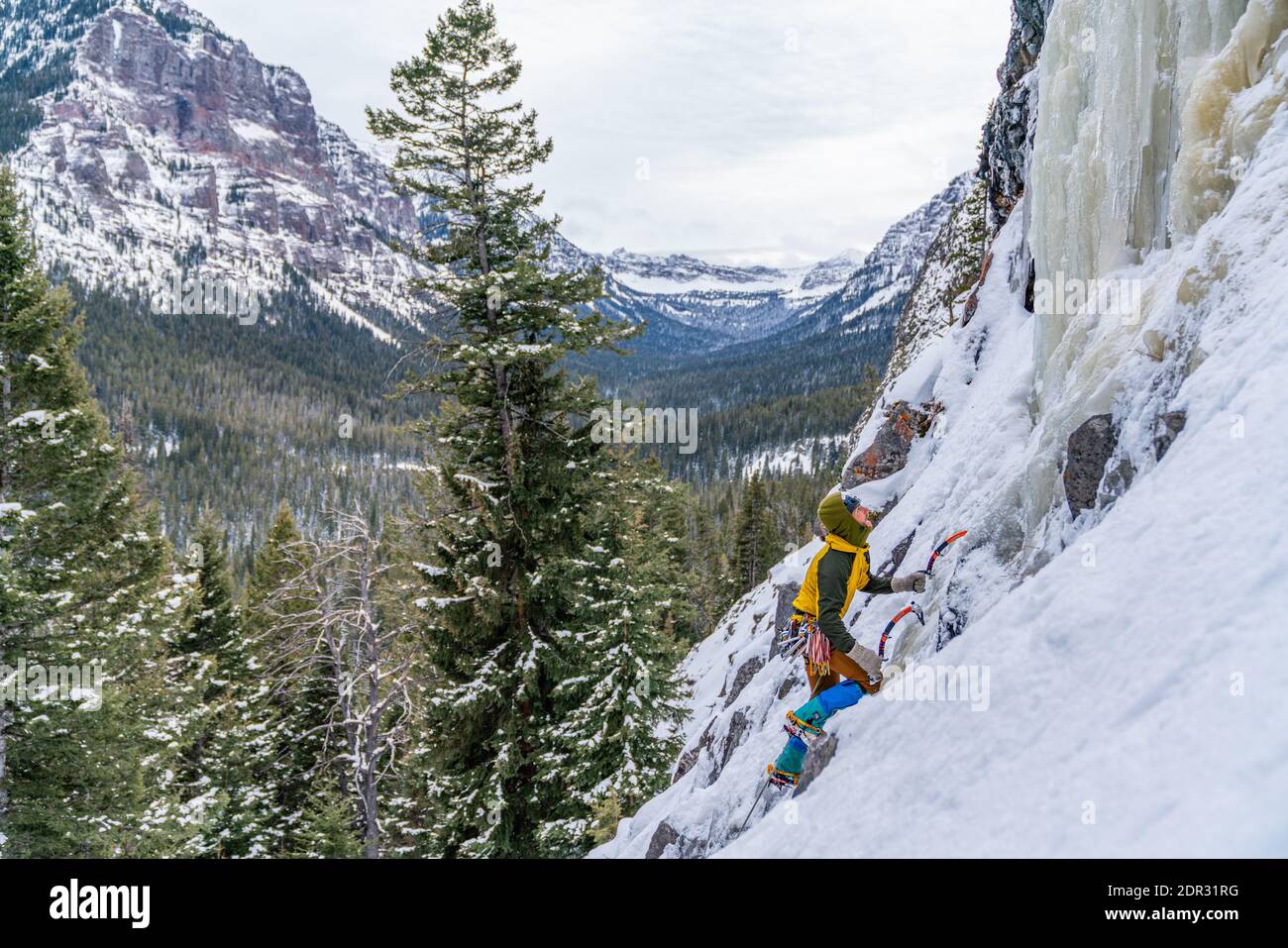 Ice climbers enjoying a day outside climbing frozen waterfalls in ...