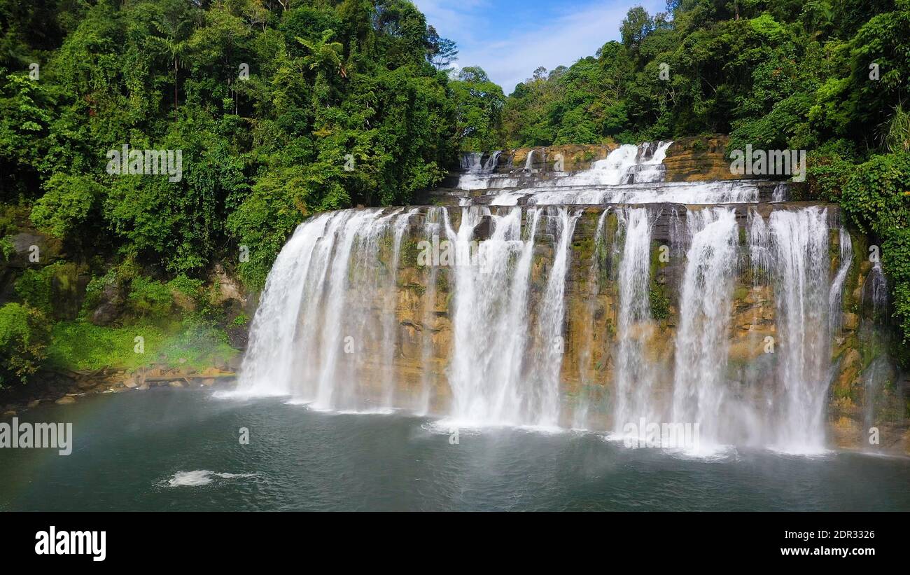 Cascade of Tinuy-an Falls in green forest, aerial drone. Waterfall in ...