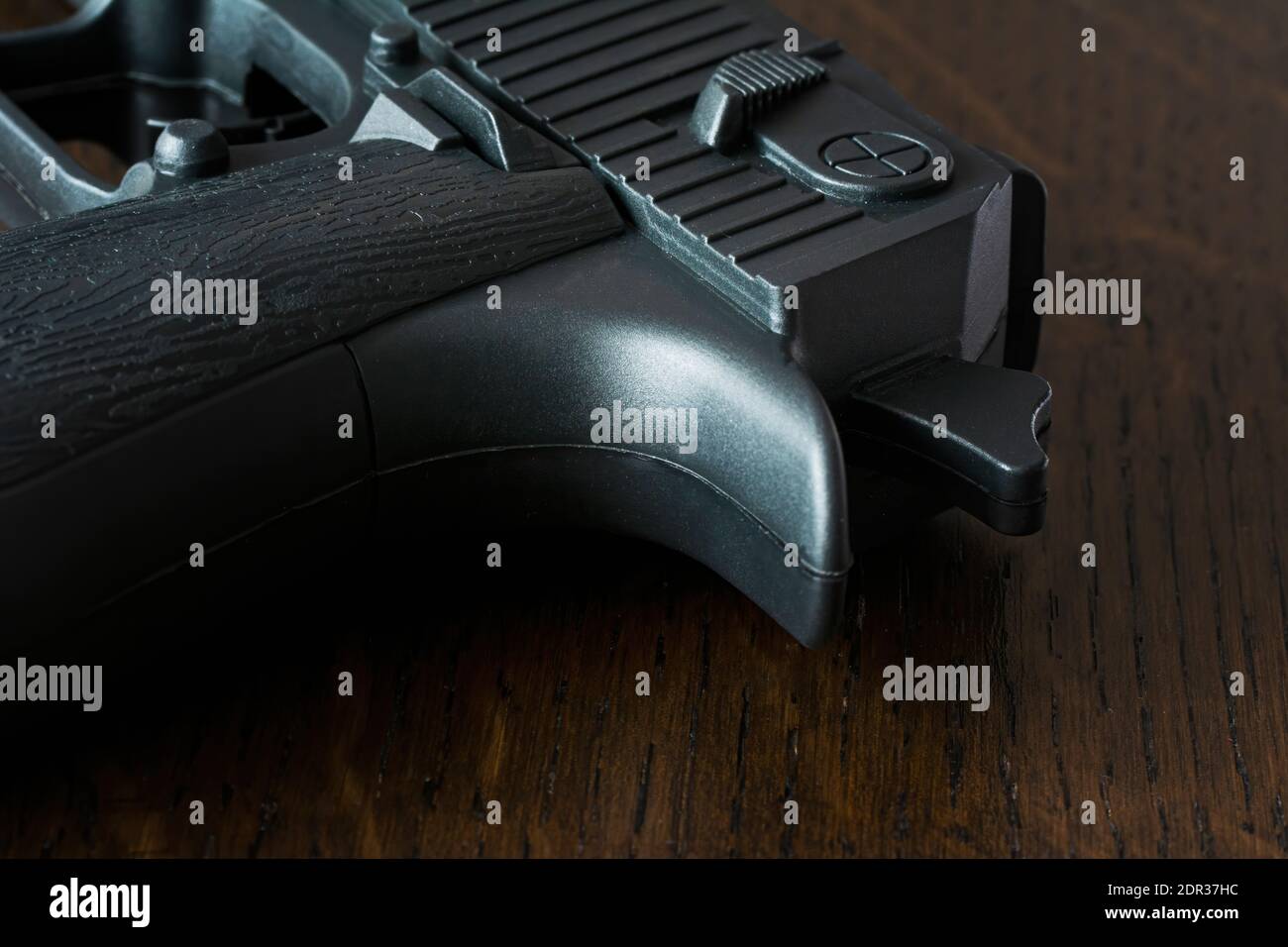 Black pistol on wooden background. Weapons for sport and self-defense ...