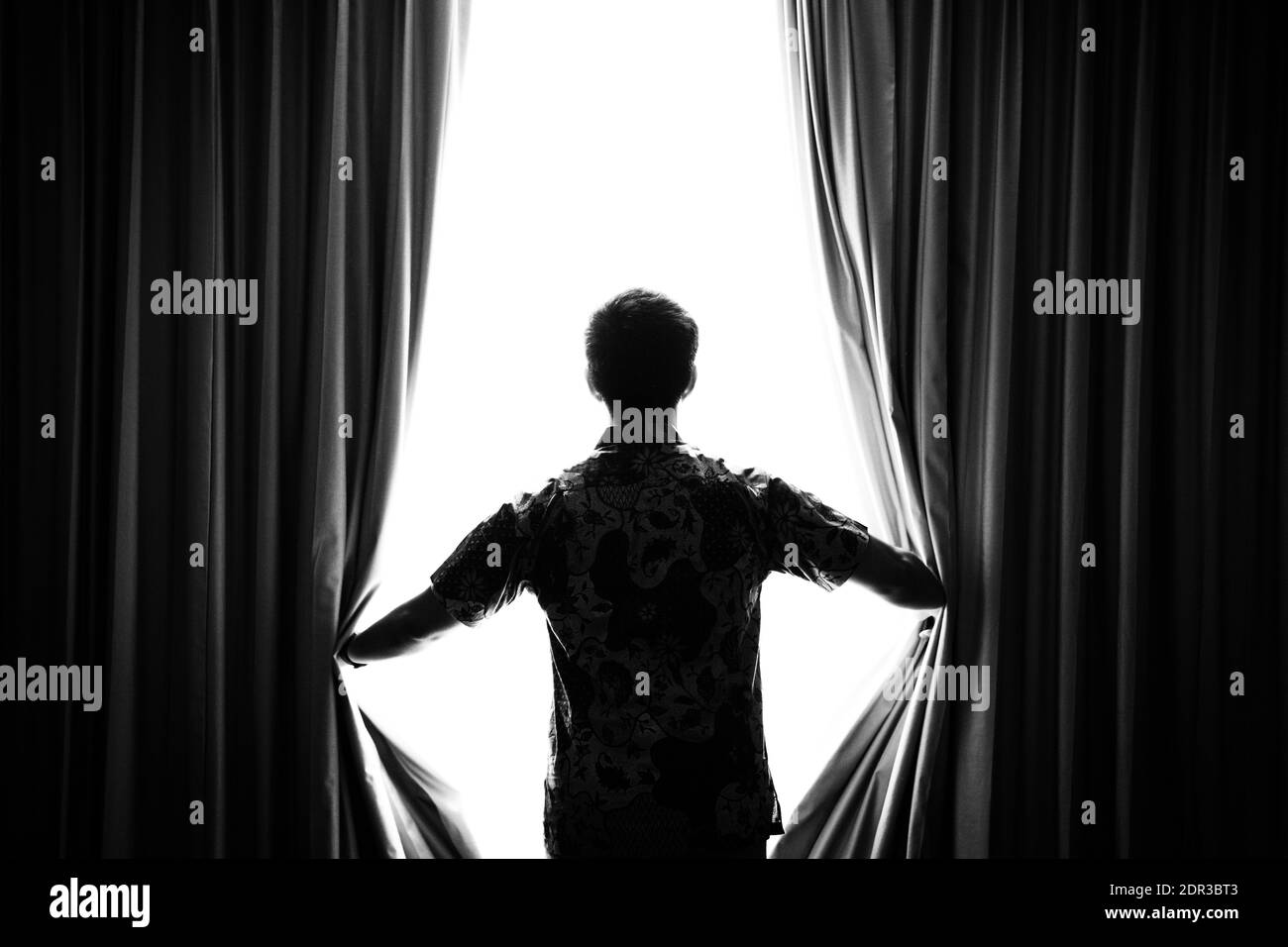 Rear View Of Man Opening Curtains On Window At Home Stock Photo - Alamy