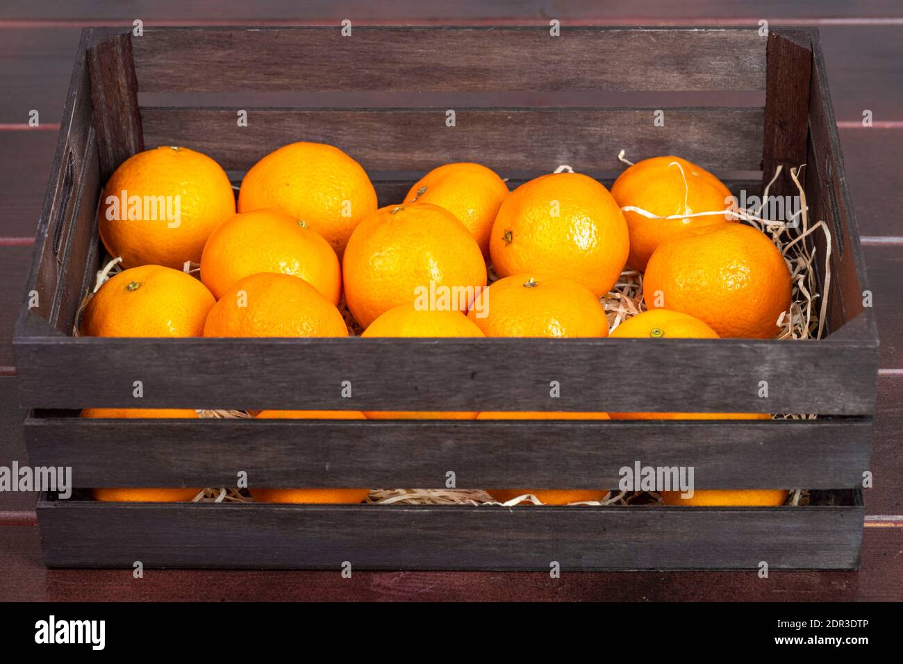 Close up view of wooden box of fresh mandarins isolated. Health and ...