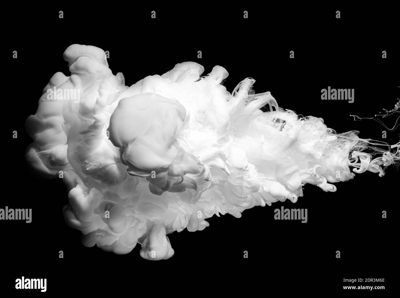 White ink in water, isolated on black background. Acrylic paint splash ...