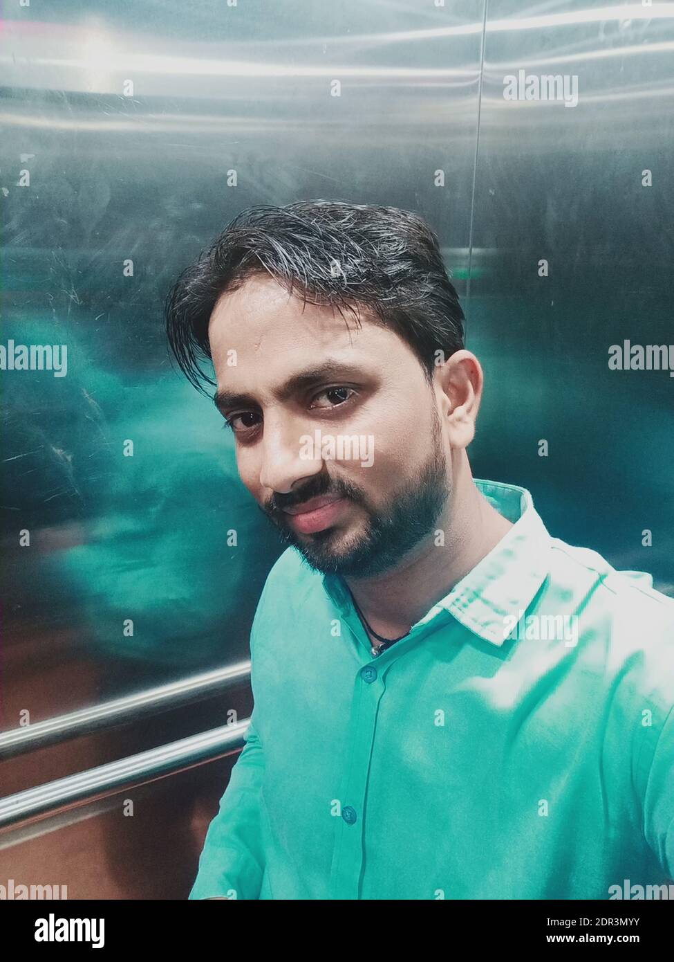 Portrait Of Young Man Inside The Lift Stock Photo - Alamy