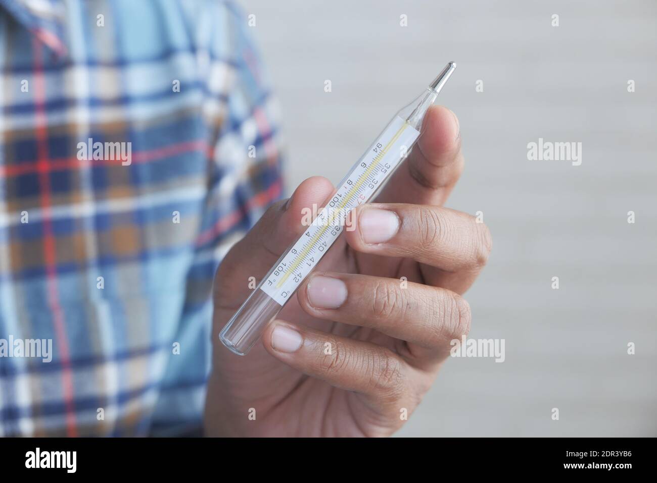 man hand holding medical thermometer on white background Stock Photo ...