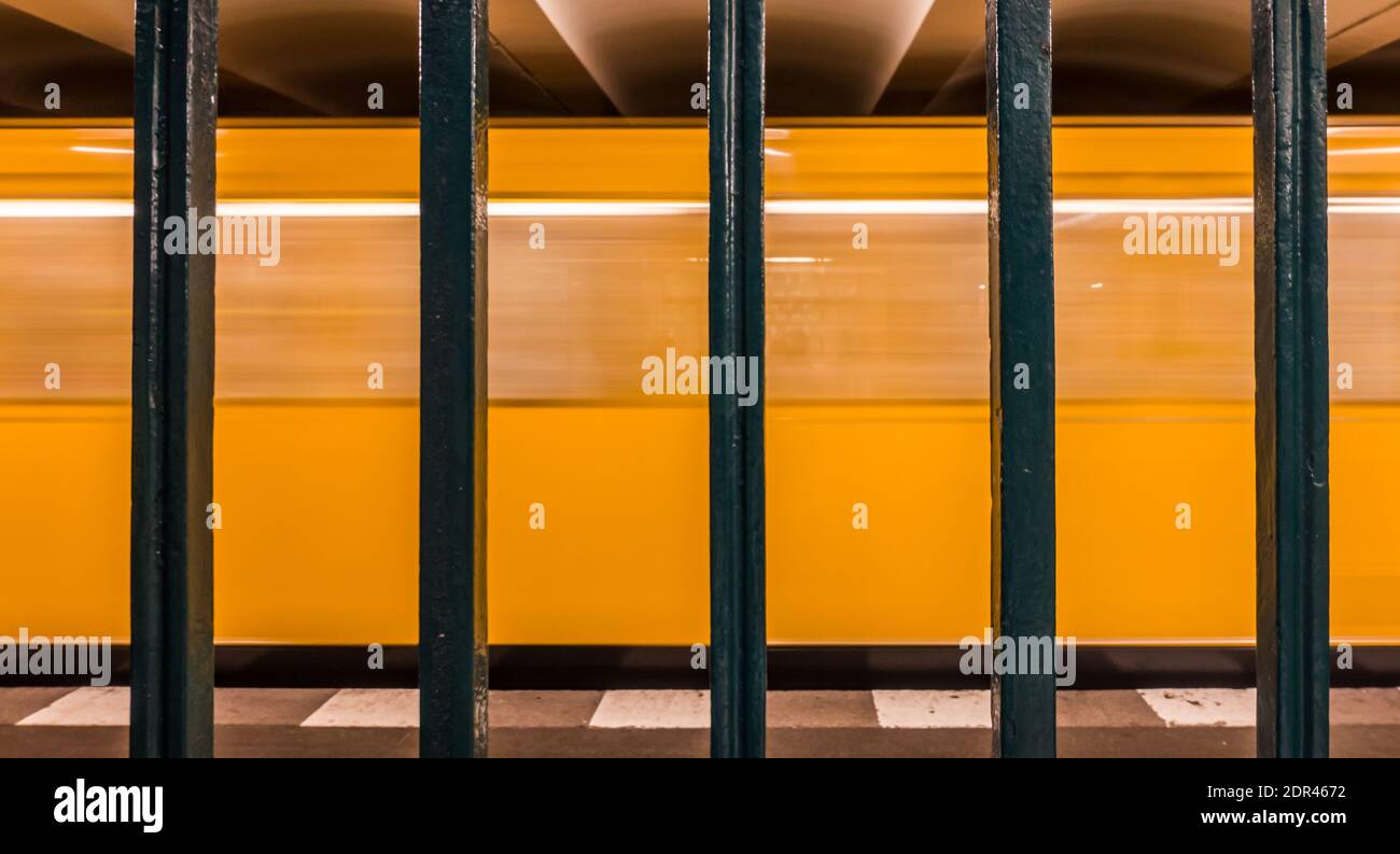 Blurred Motion Of Yellow Train Seen From Gate Stock Photo - Alamy