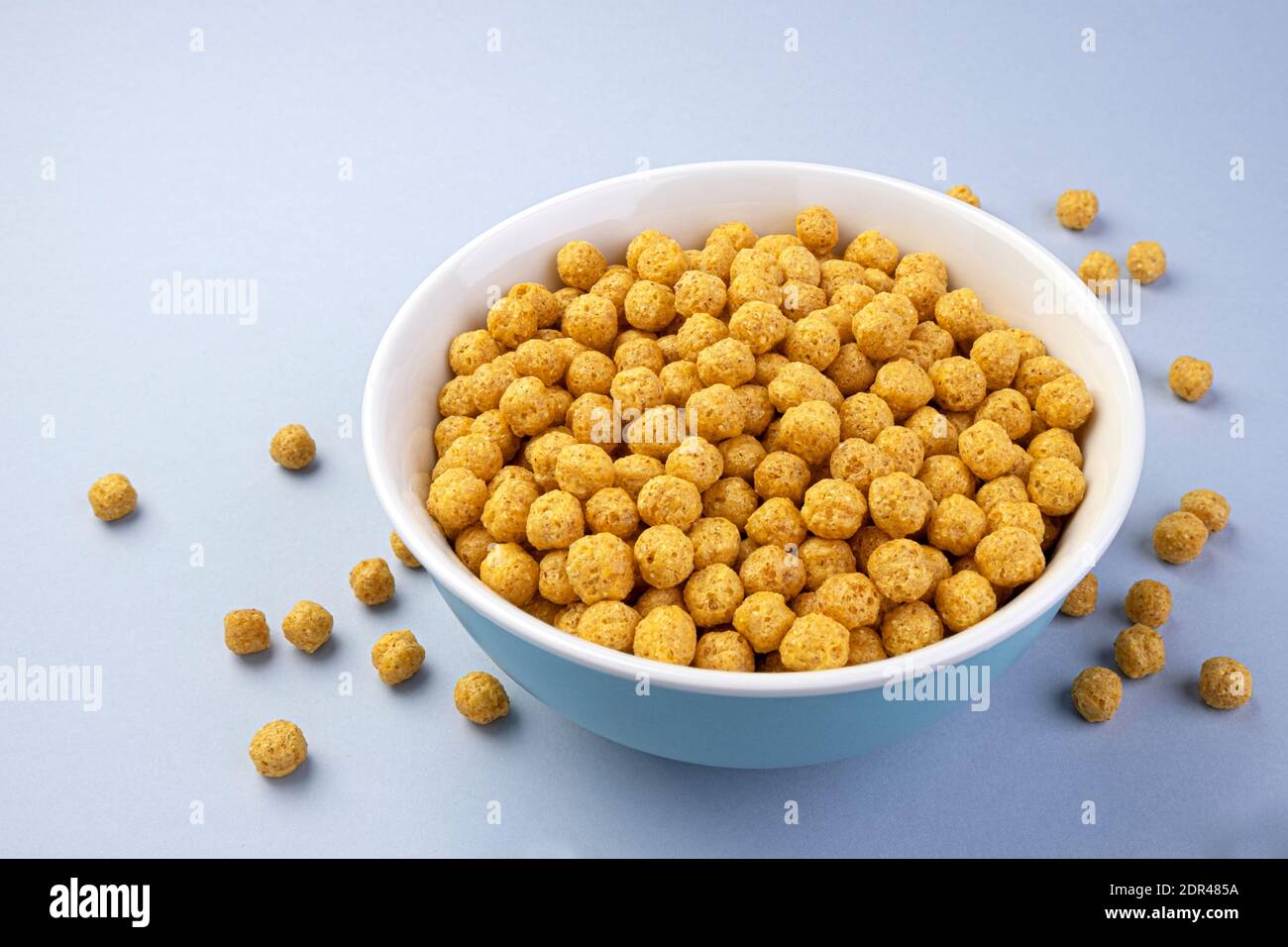 Corn balls in bowl on white background Stock Photo - Alamy