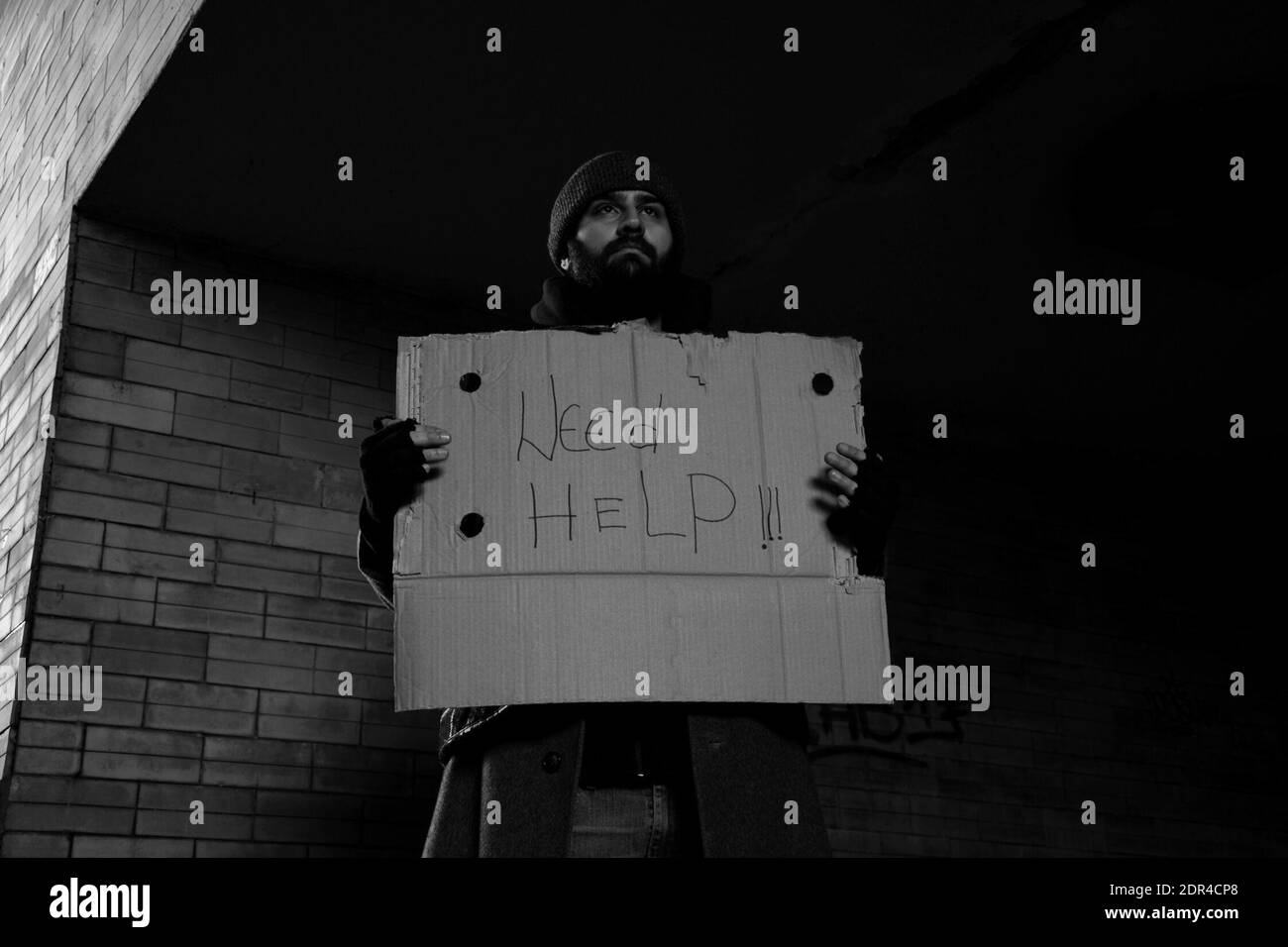 Homeless person with sign begging Black and White Stock Photos & Images ...