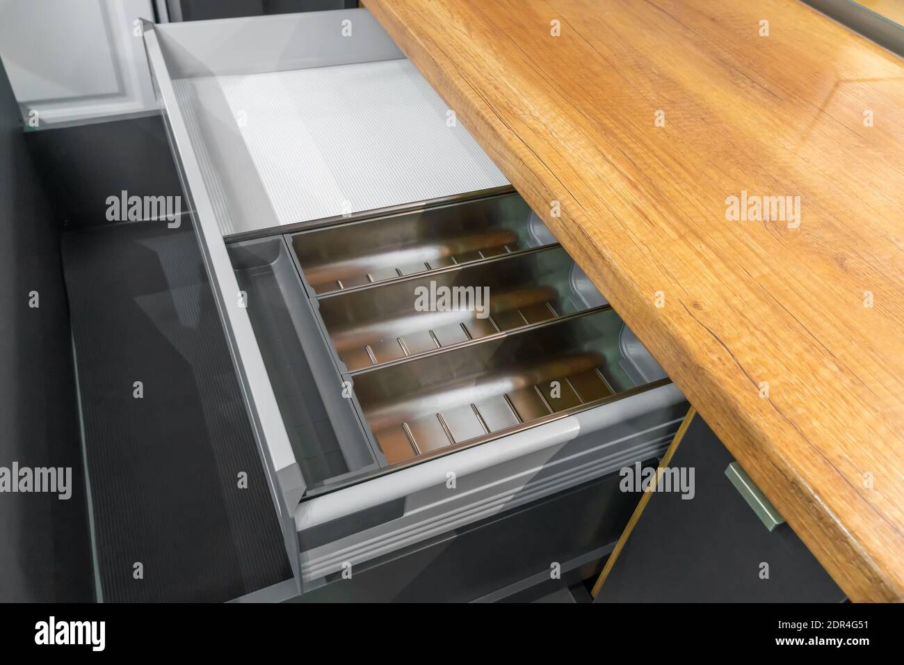 Open kitchen drawer with empty Cutlery tray. Two drawers are hidden ...