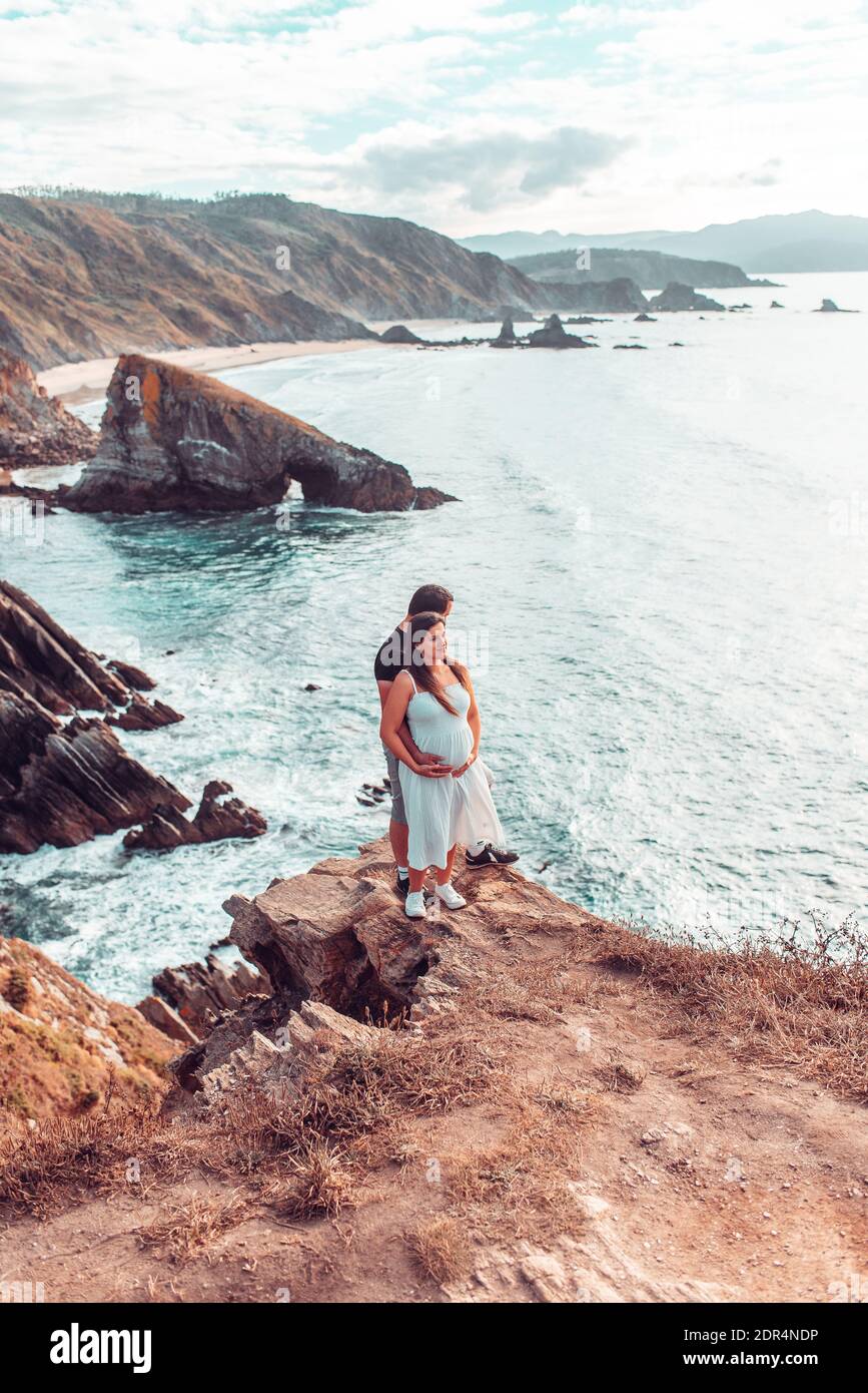 Woman Sitting On Rock At Beach Stock Photo - Alamy