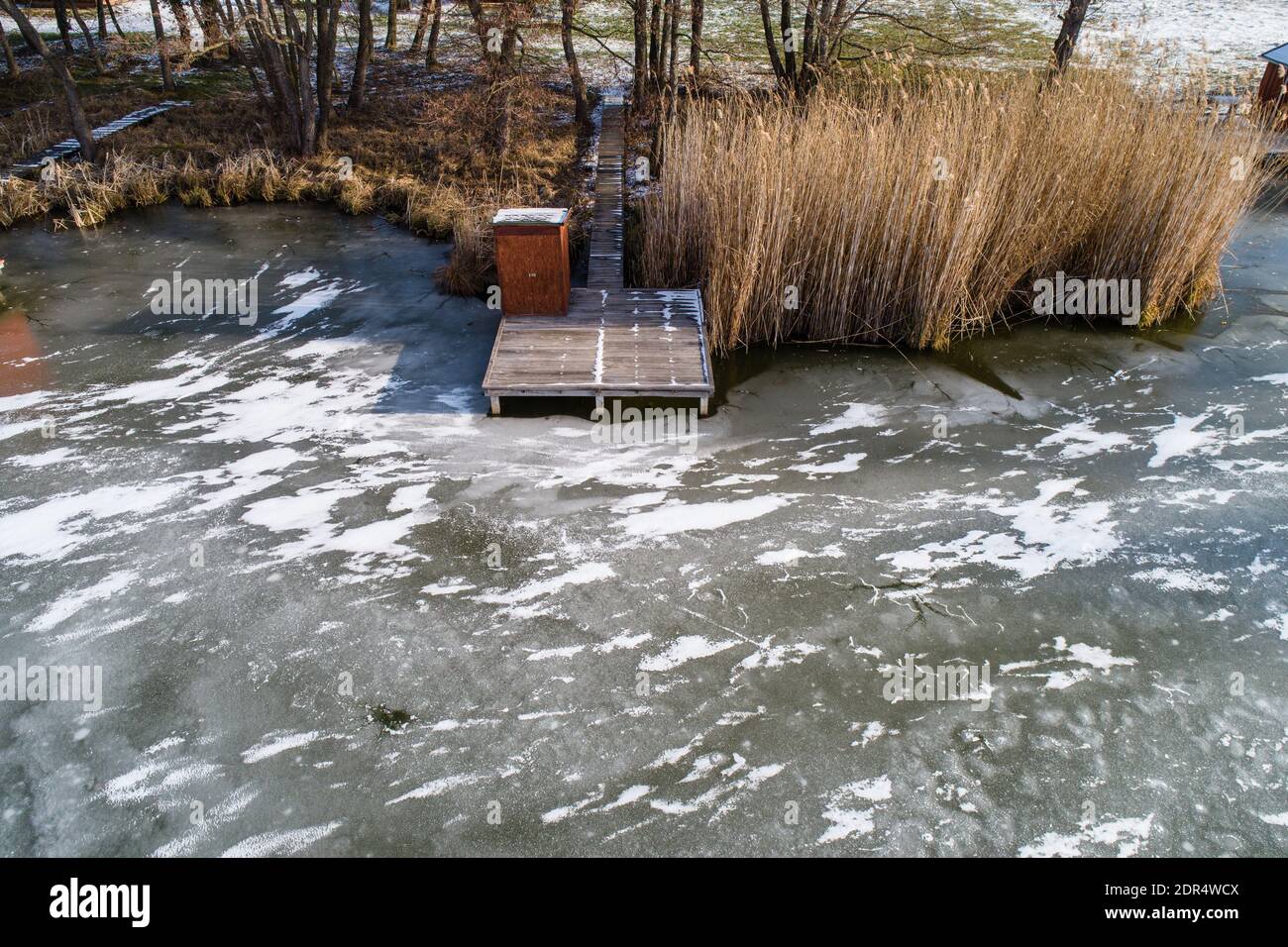 Aerial view of winter frozen lake with wooden houses on pier Stock ...