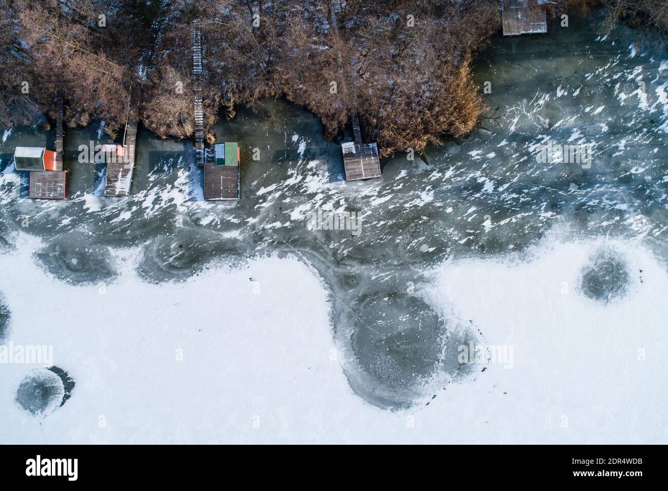 Aerial view of winter frozen lake with wooden houses on pier Stock ...