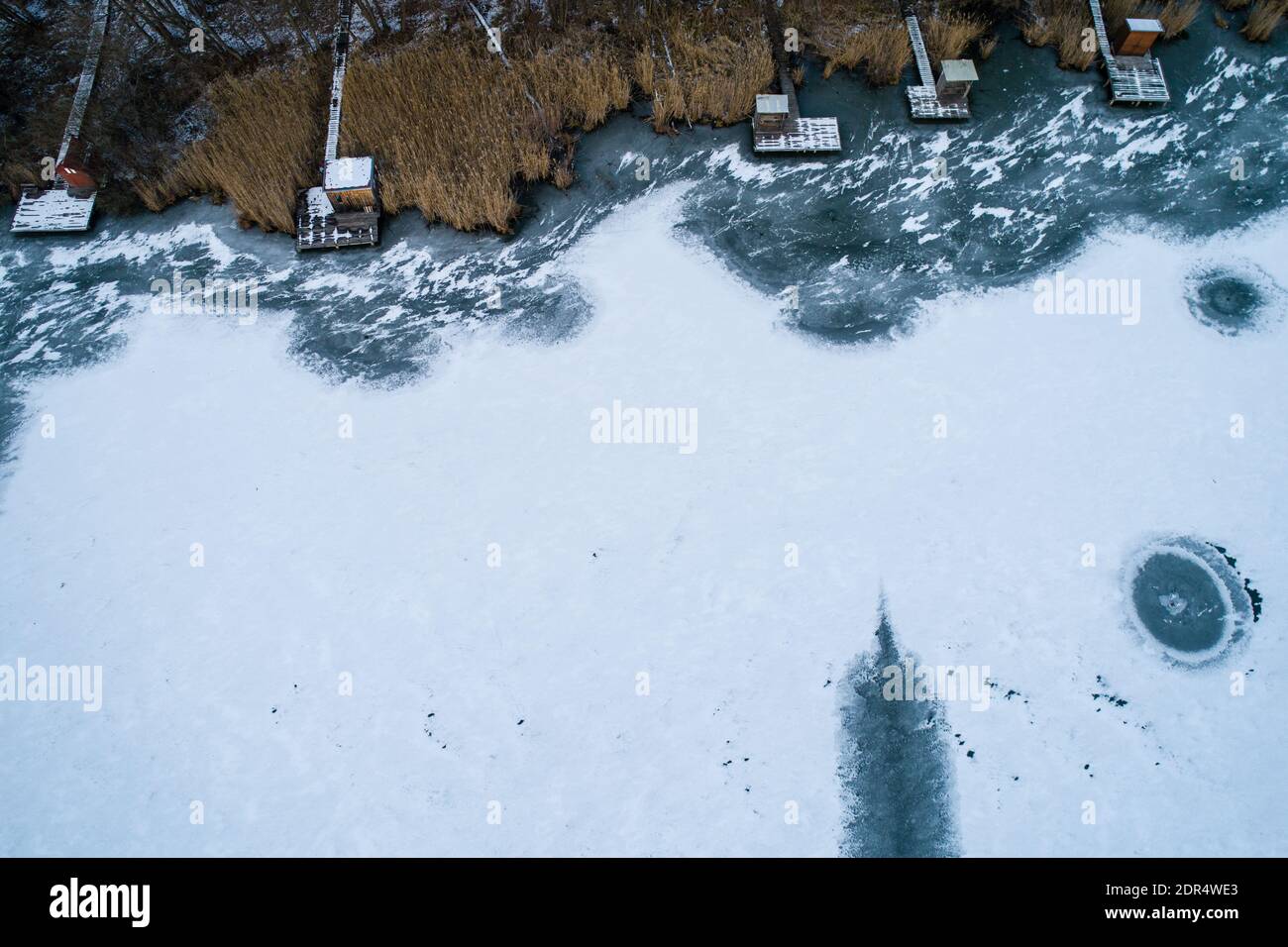 Aerial view of winter frozen lake with wooden houses on pier Stock ...